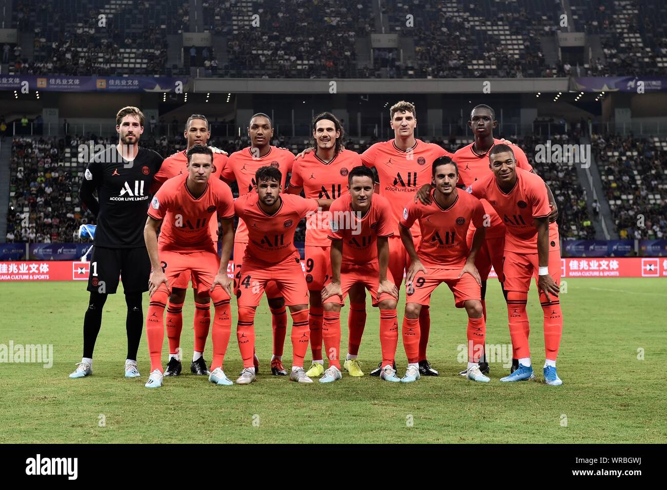 Players of the starting line-up of Paris Saint-Germain pose for photos ...