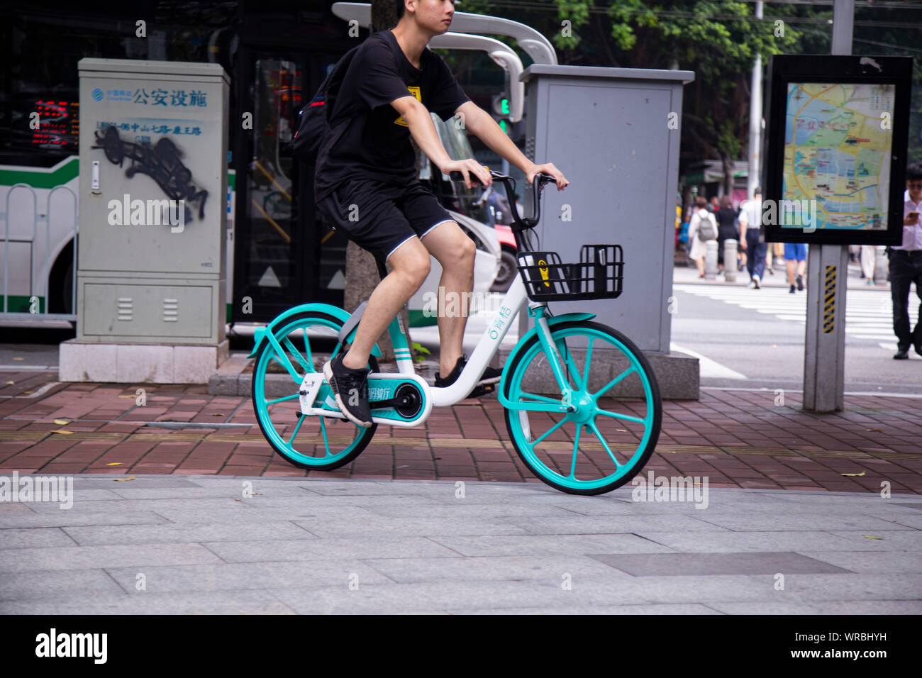 A commuter rides a shared bicycle of bike-sharing service Qingju on the ...