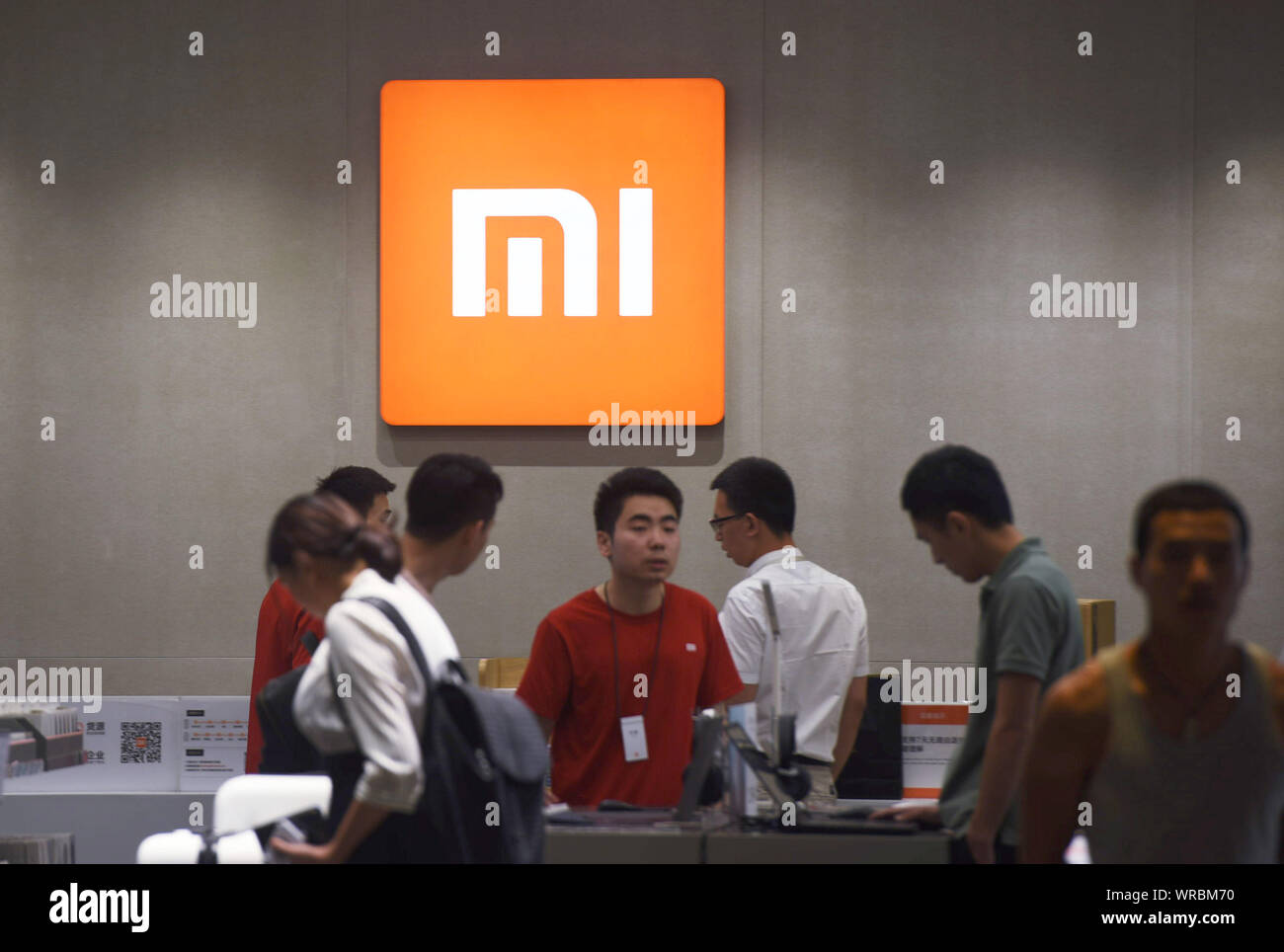 Chinese shoppers visit a store of Xiaomi in Hangzhou City, east China's ...