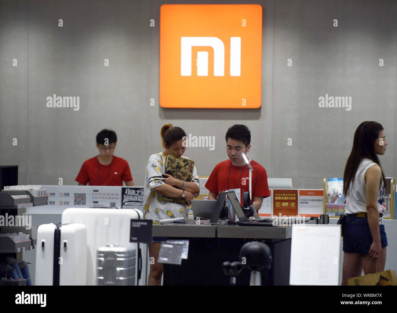 Chinese shoppers visit a store of Xiaomi in Hangzhou City, east China's ...
