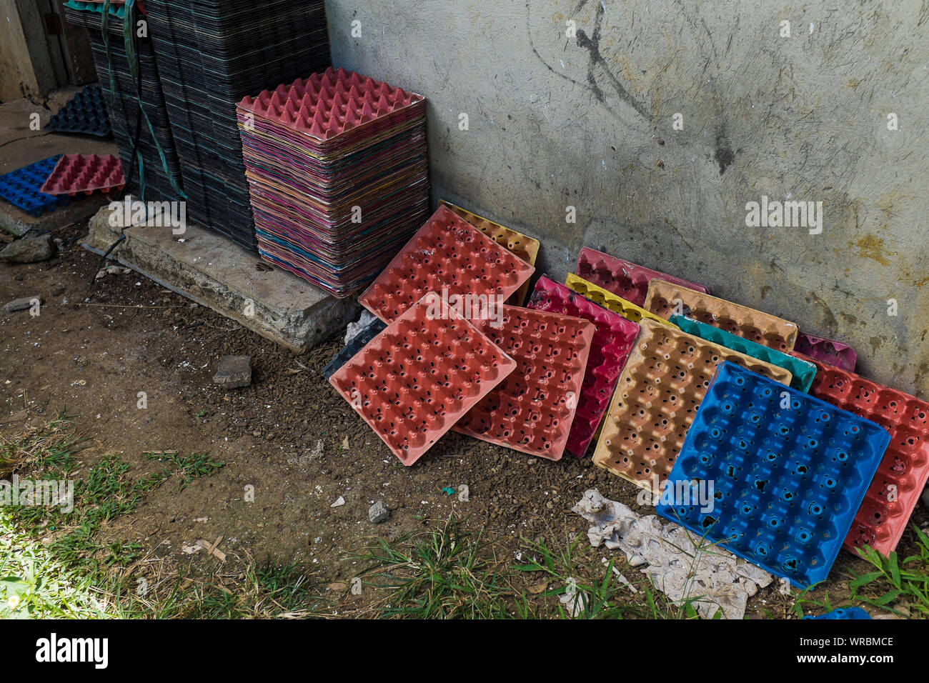 Stack Of Colorful Egg Cartons Against Wall Stock Photo - Alamy