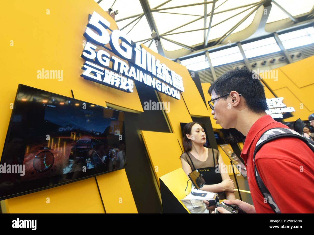 A visitor tries out an electric video game in the 5G Training Room ...