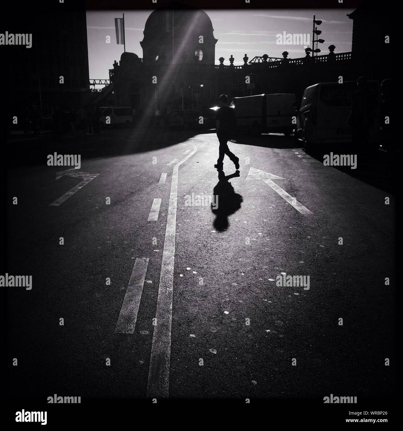 Man Walking With Shadow On City Street Stock Photo - Alamy