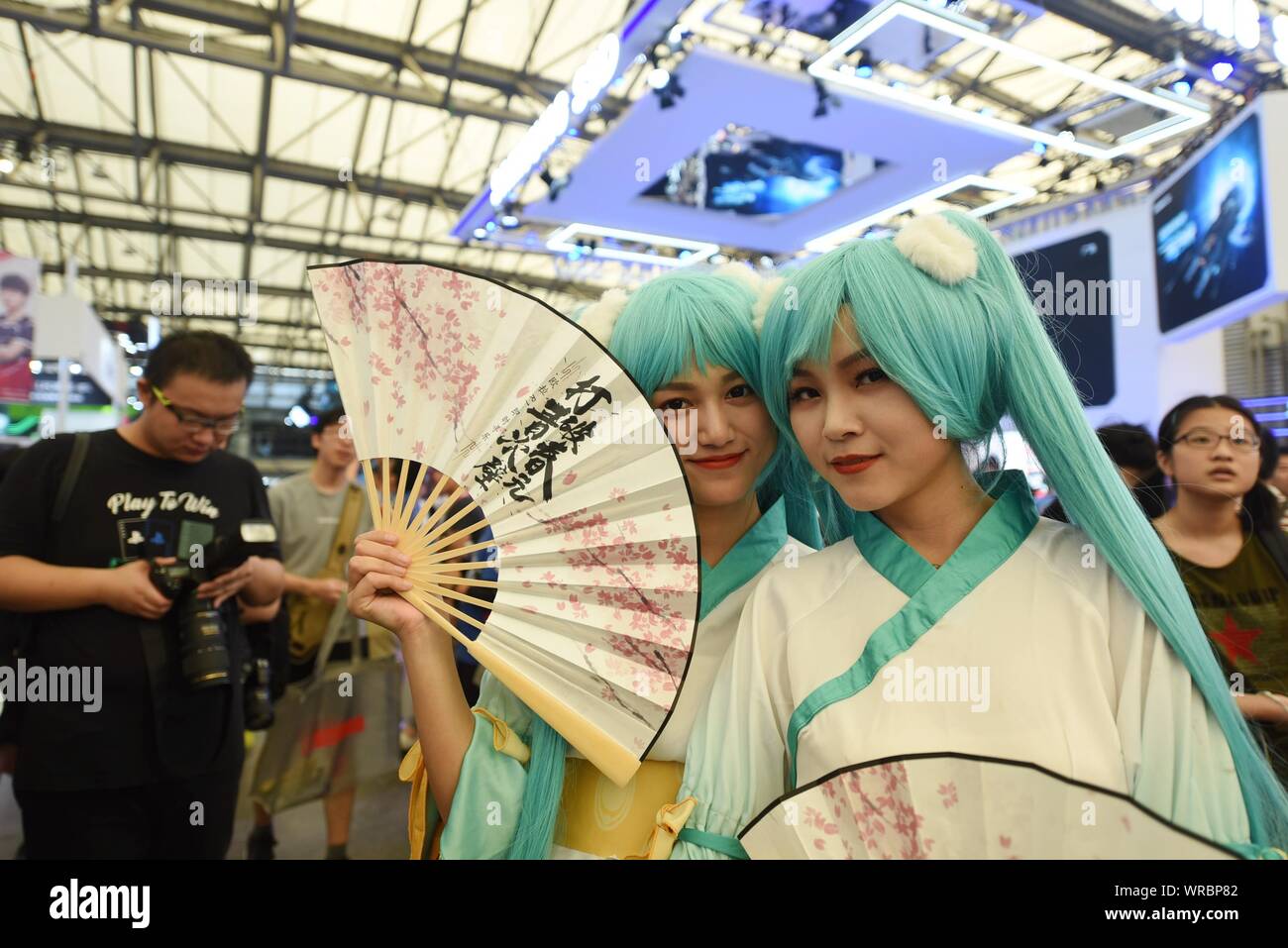 Showgirls dressed in cosplay costumes pose during the 17th China ...