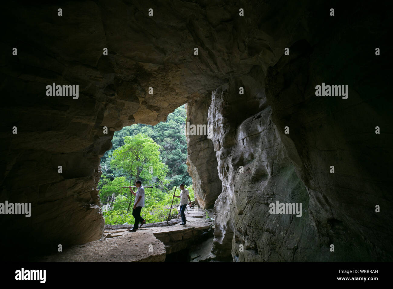 Chinese villagers maintain the Falang Canal built into the cliff in ...