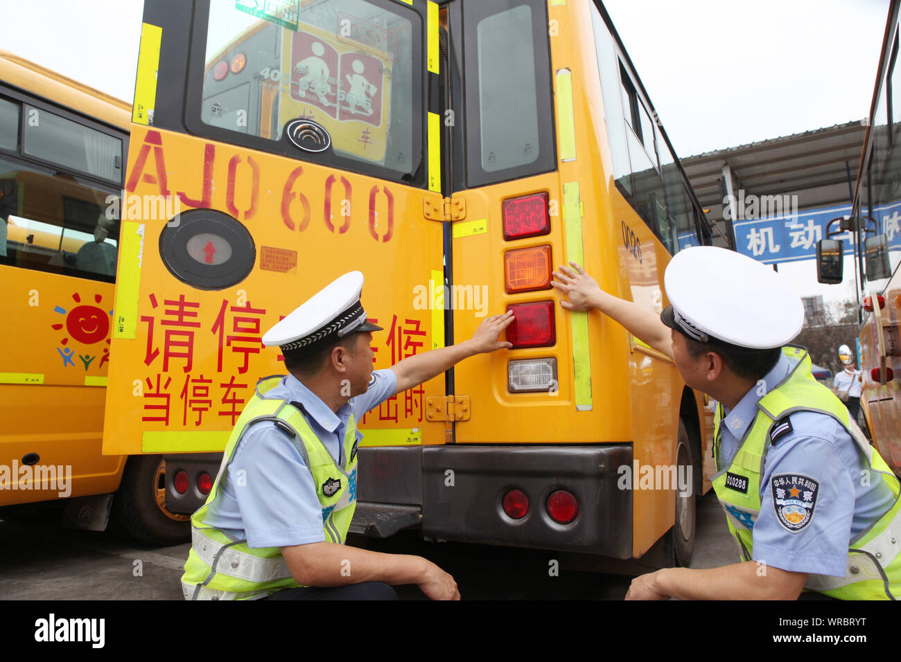 Chinese police officers examine a schoolbus during a checkup session ...