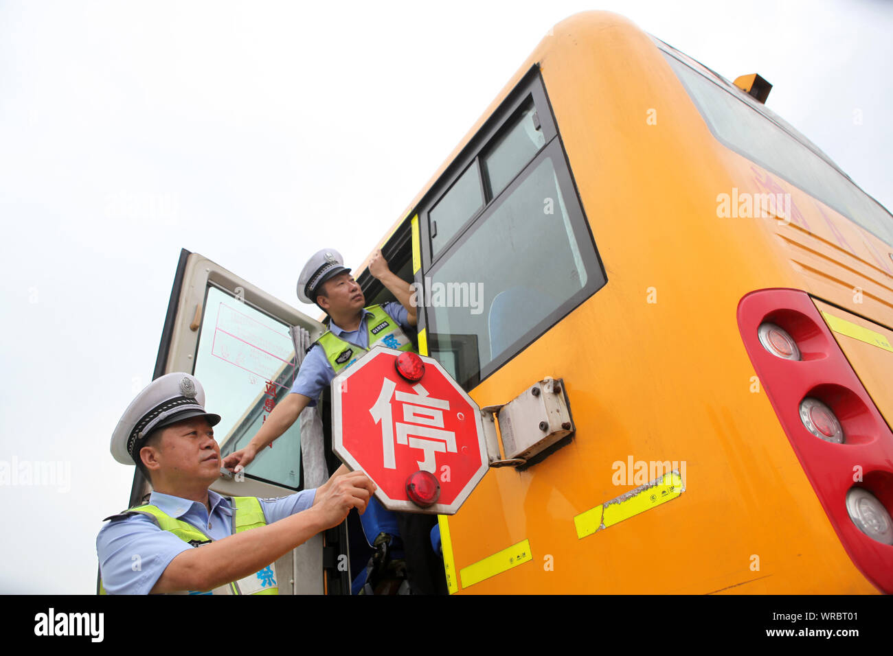 Chinese police officers examine a schoolbus during a checkup session ...