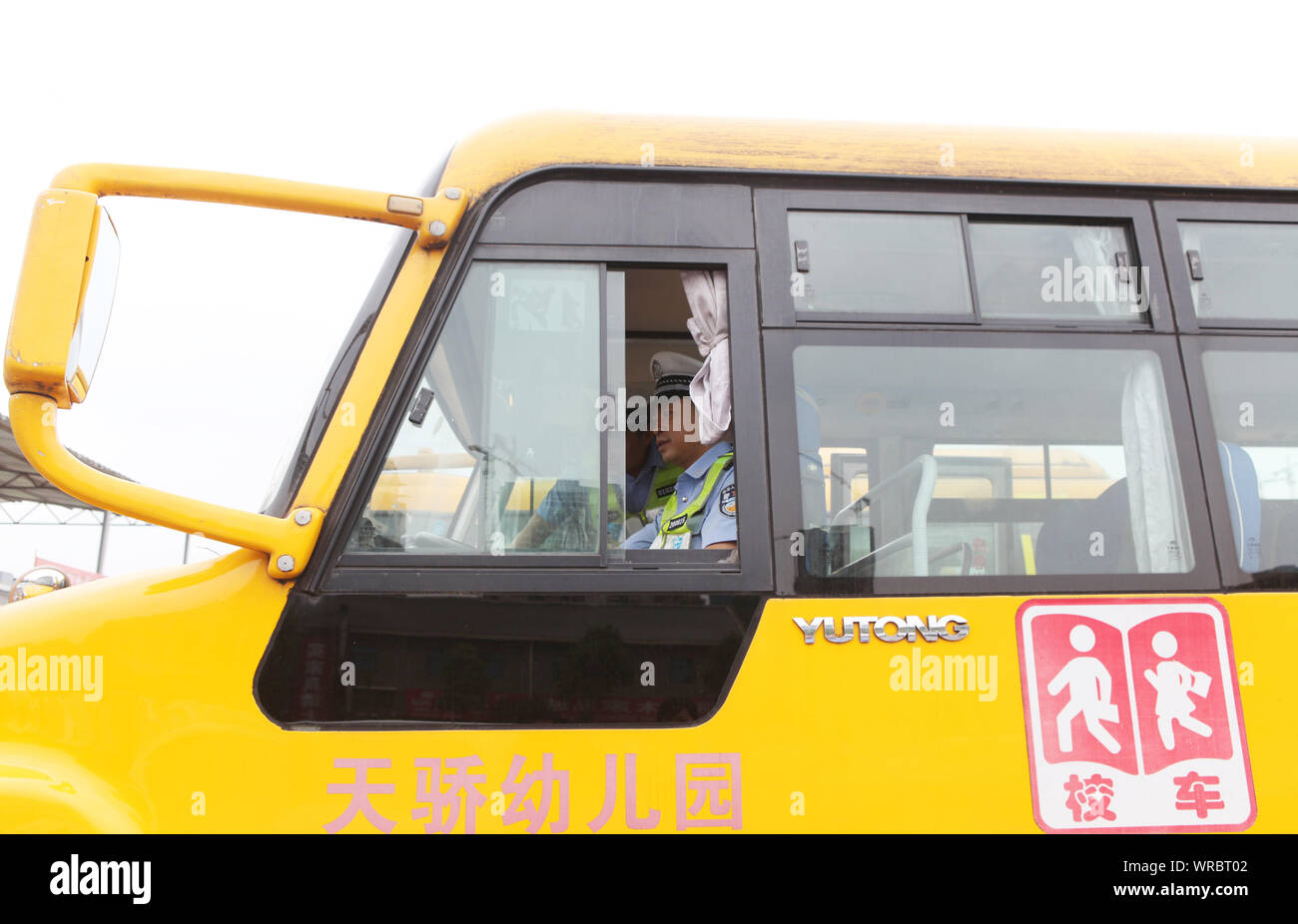 Chinese police officers examine a schoolbus during a checkup session ...