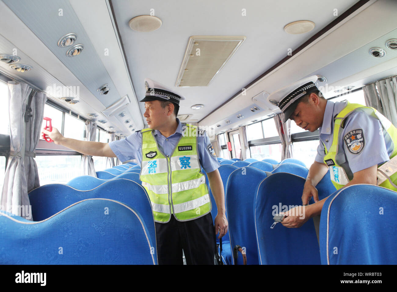 Chinese police officers examine a schoolbus during a checkup session ...