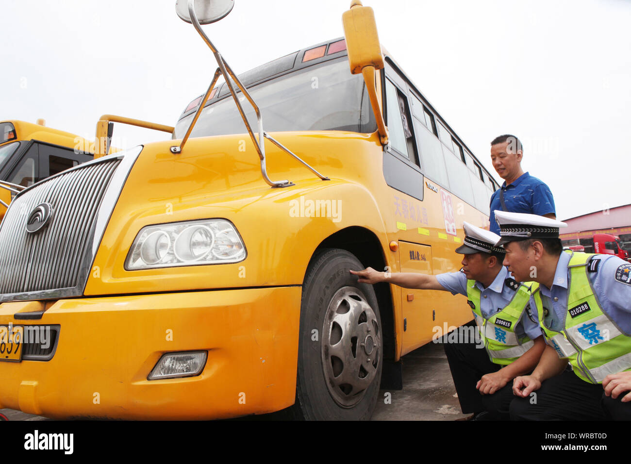 Chinese police officers examine a schoolbus during a checkup session ...