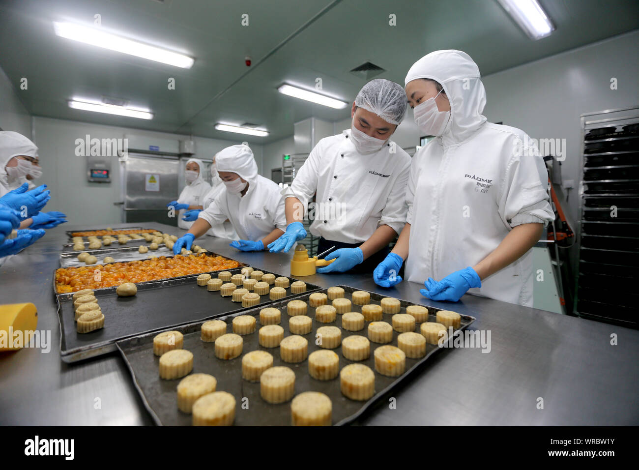 Chinese workers make mooncakes for the upcoming Mid-Autumn Festival at ...
