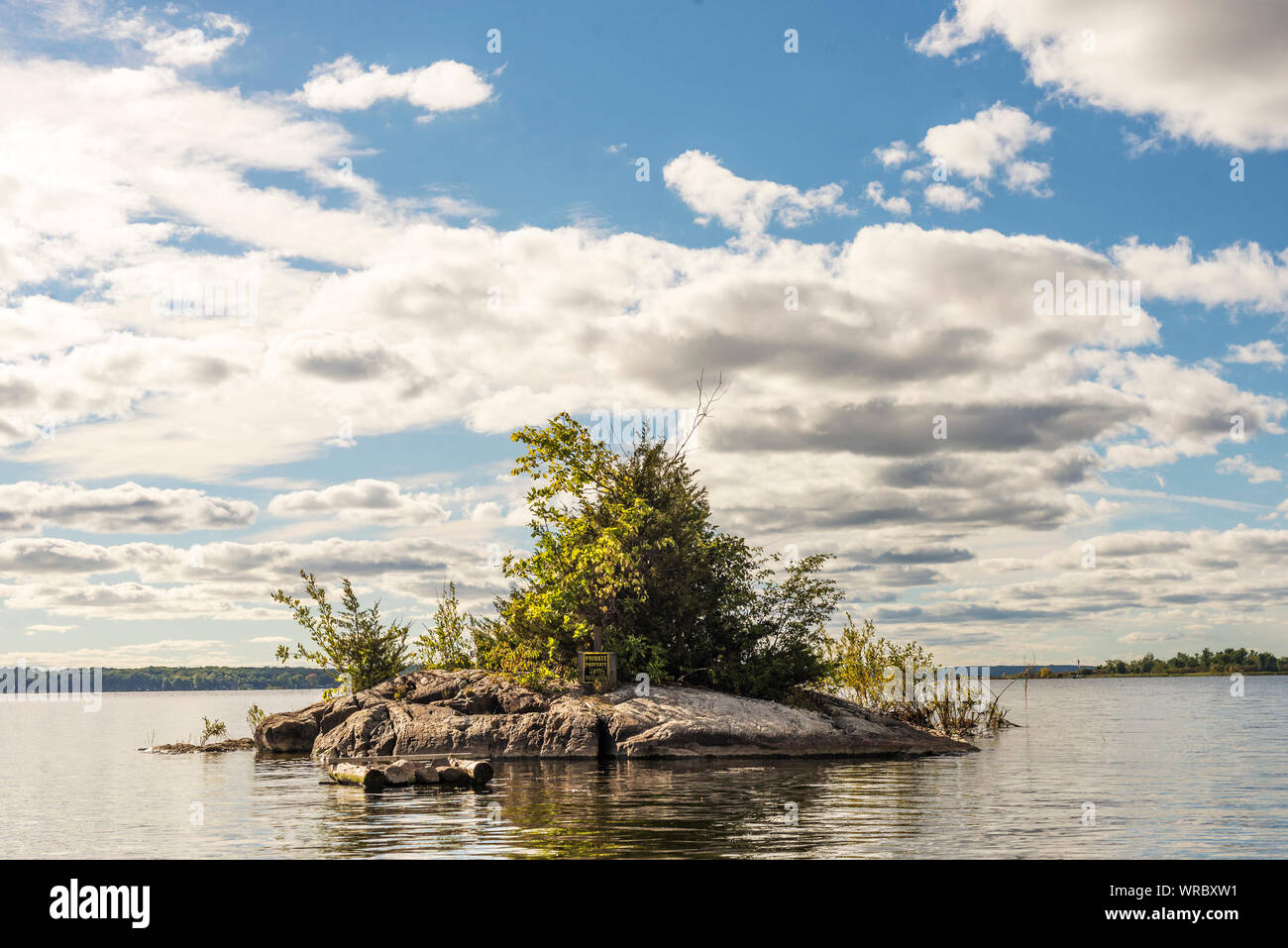 A small island in one of the many lakes in cottage country Ontario ...