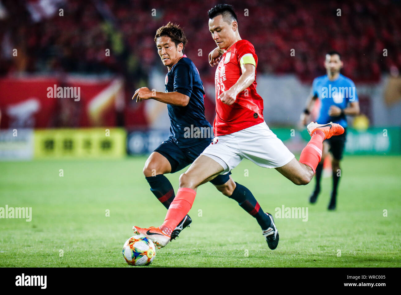 Gao Lin, right, of China's Guangzhou Evergrande challenges Ryota Nagaki ...