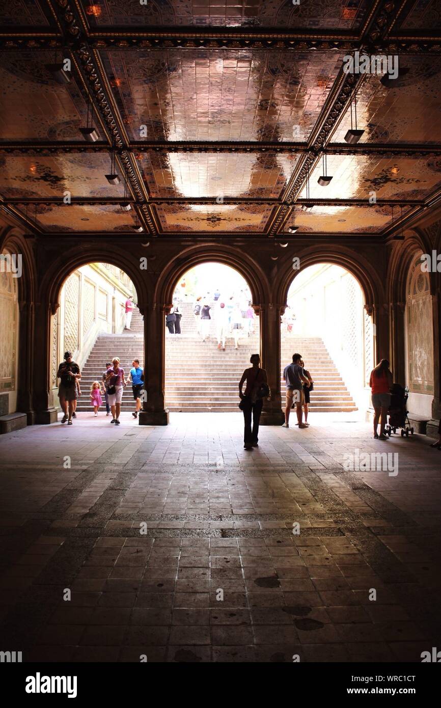 View Of People Walking Under Arched Structure Stock Photo - Alamy