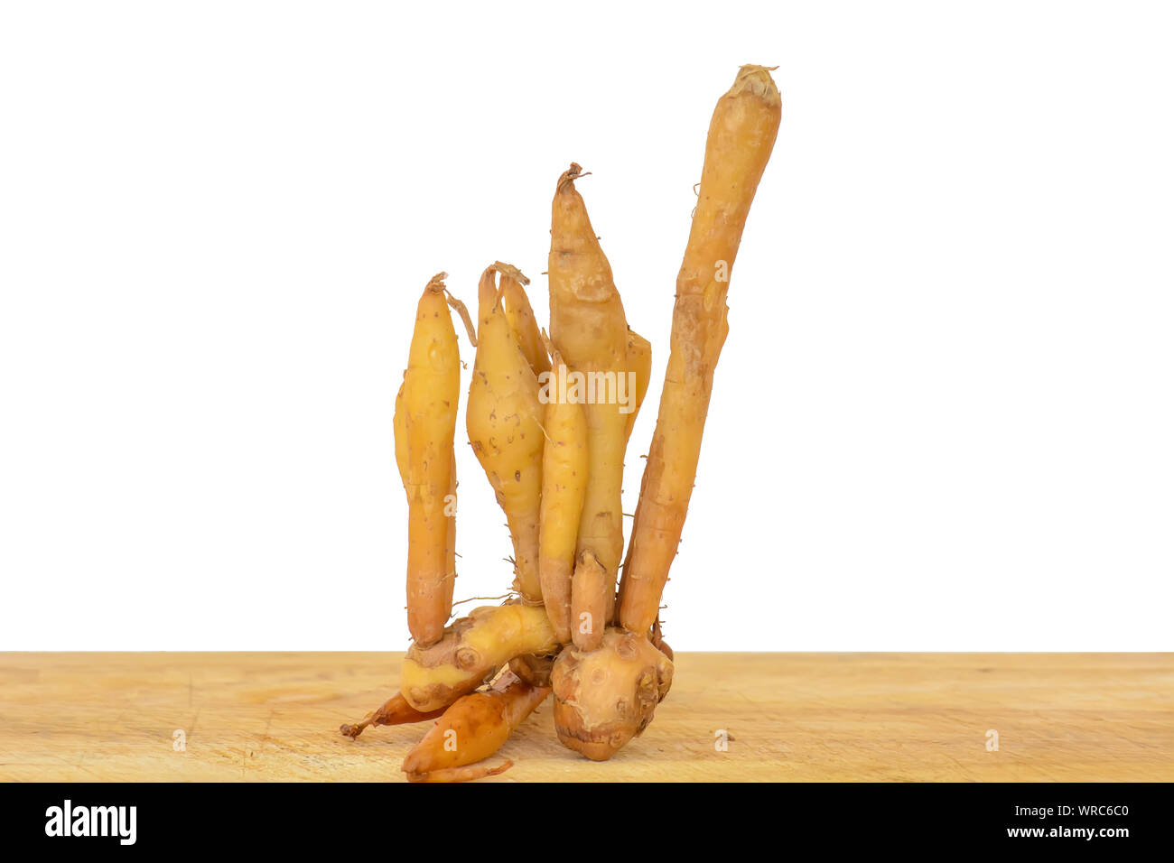 Galingale on the chopping board wood isolated on a white background ...