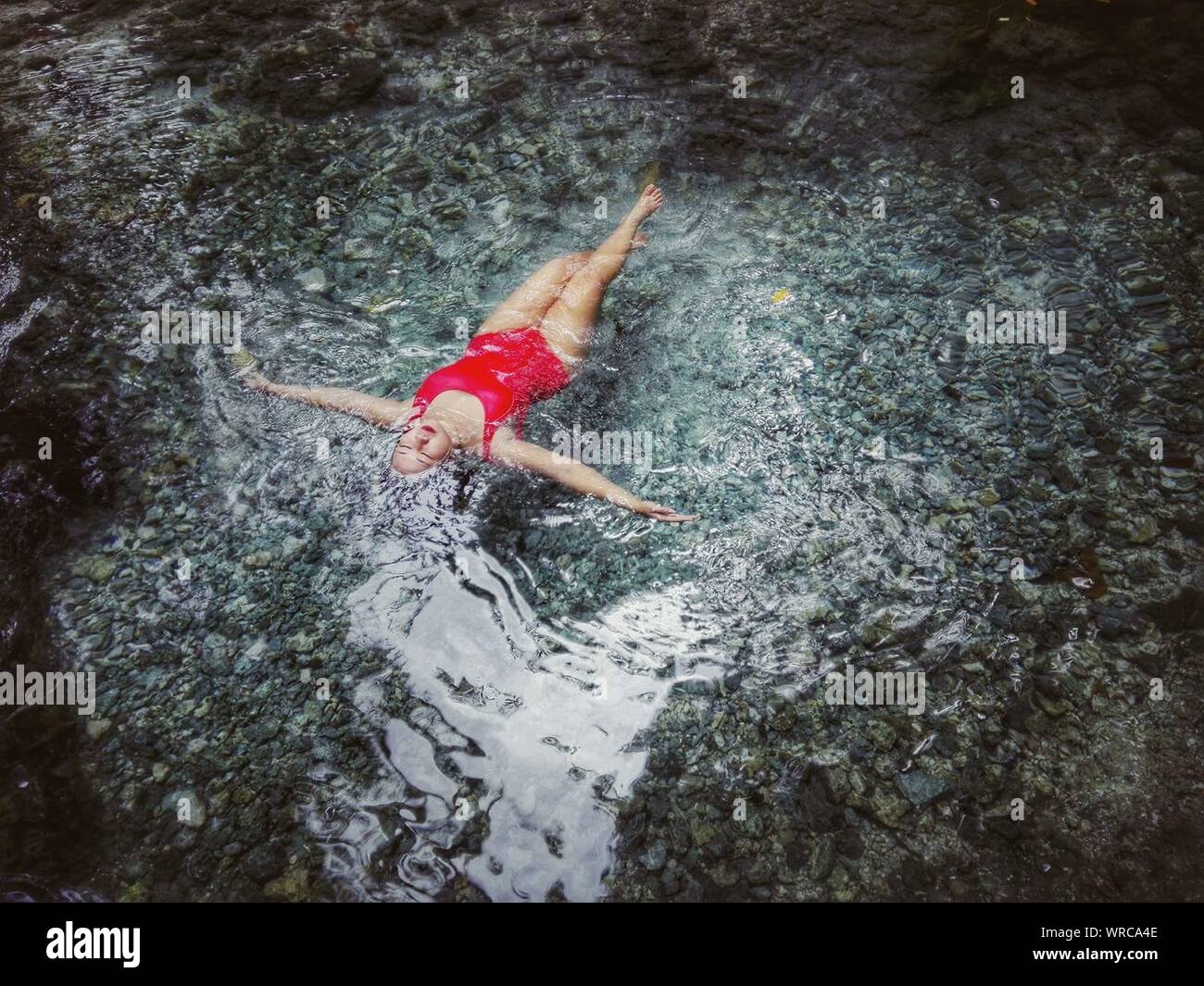 Woman floating on back in water hi-res stock photography and images - Alamy
