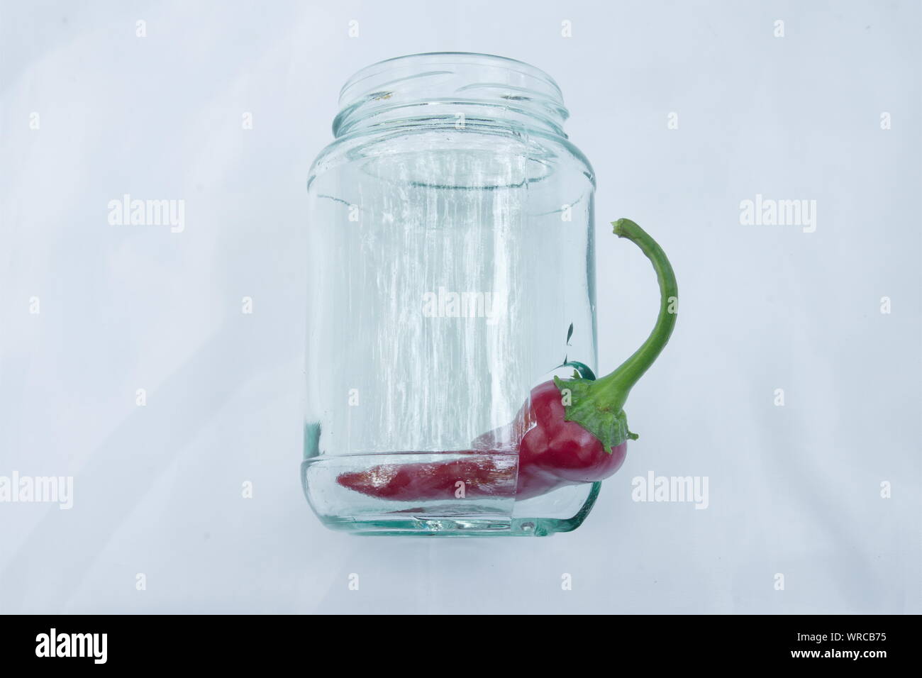 Red hot chili pepper in a broken jar Stock Photo - Alamy