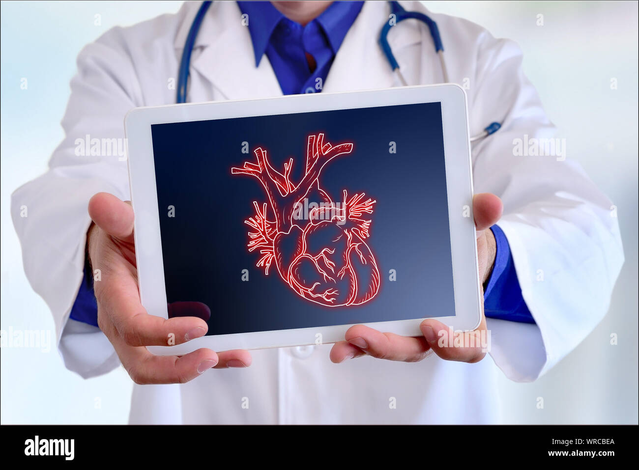 Doctor showing a picture of a heart on a tablet in a hospital Stock ...