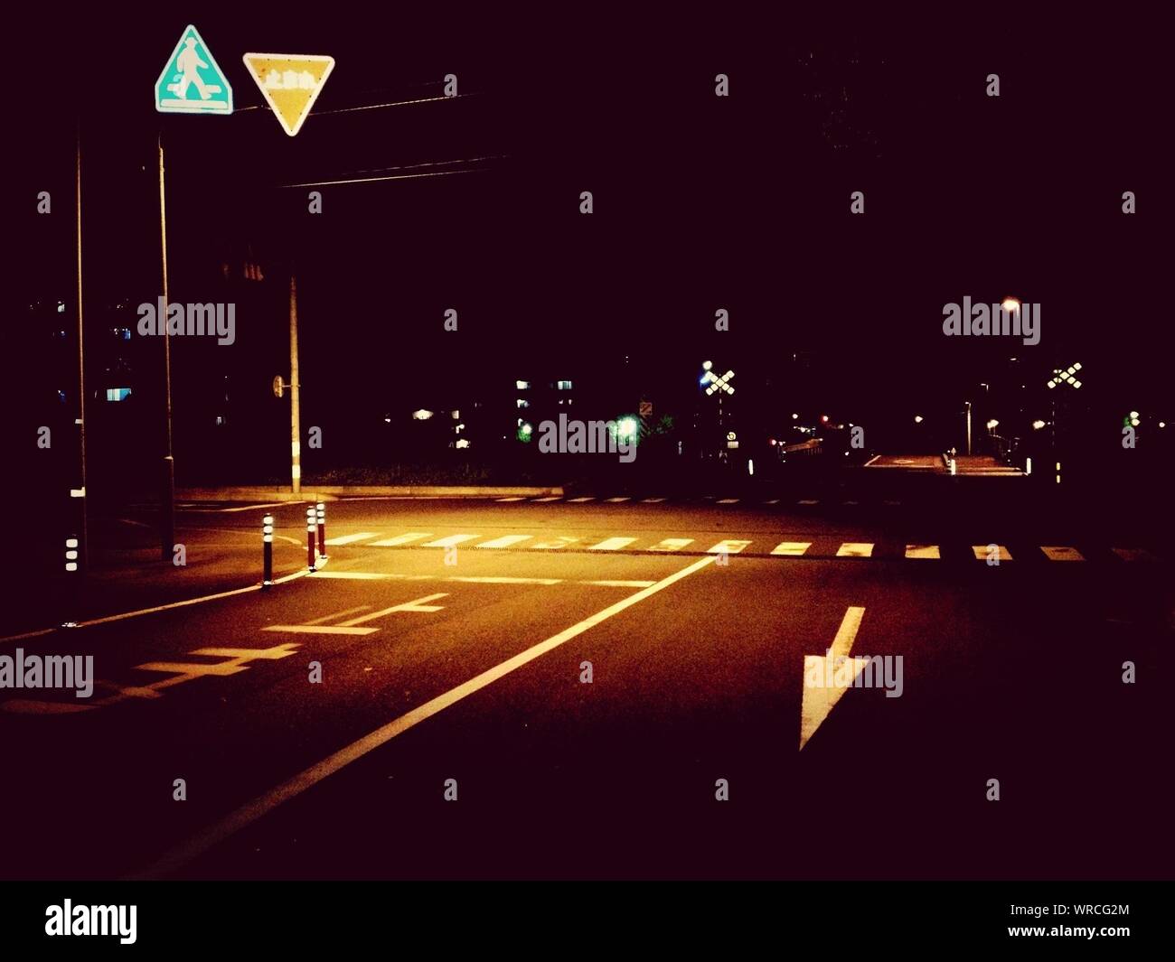 View Of Signs On Urban Street At Night Stock Photo - Alamy