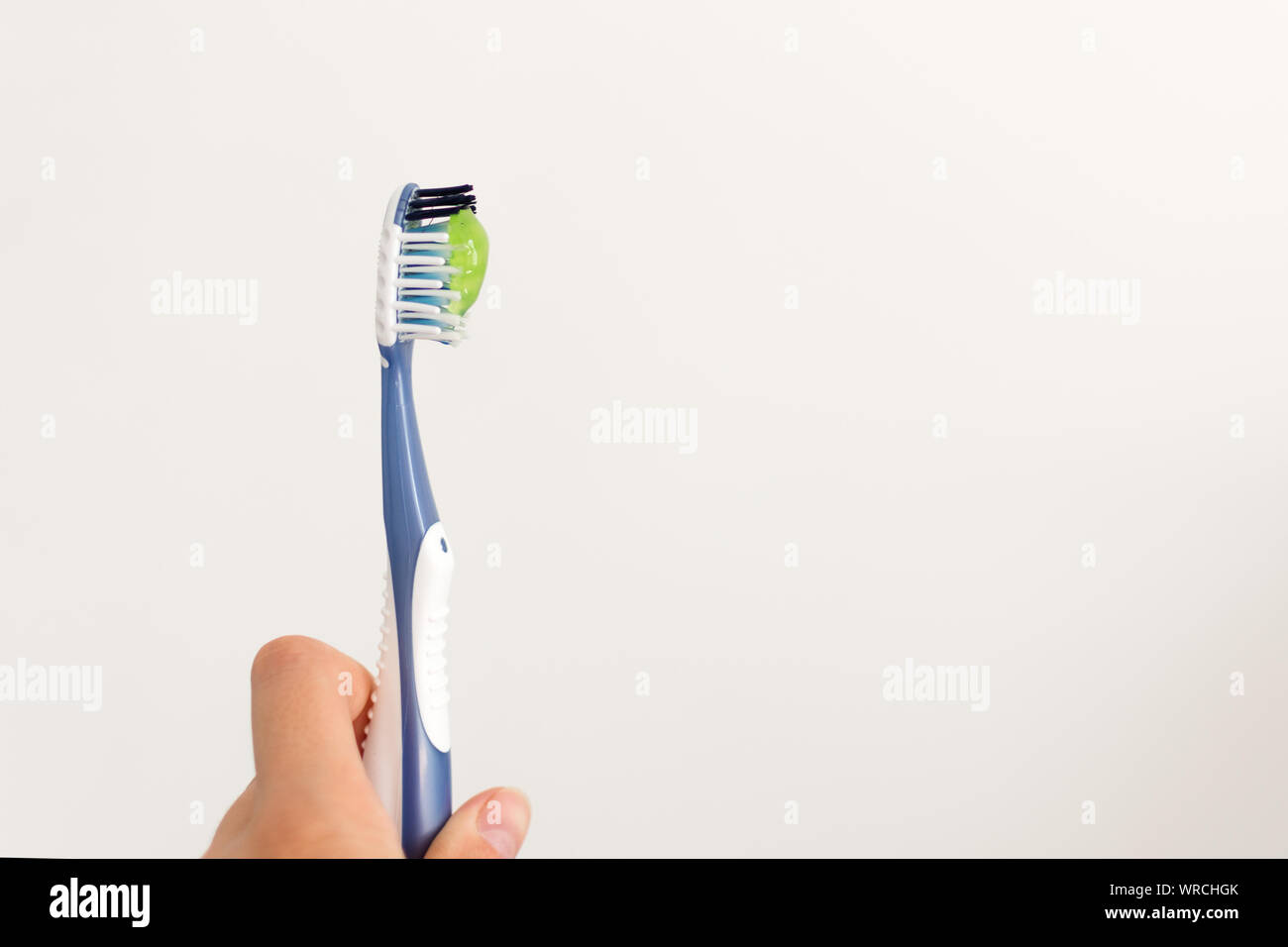 Toothbrush with green toothpaste on white background. Copy space Stock ...