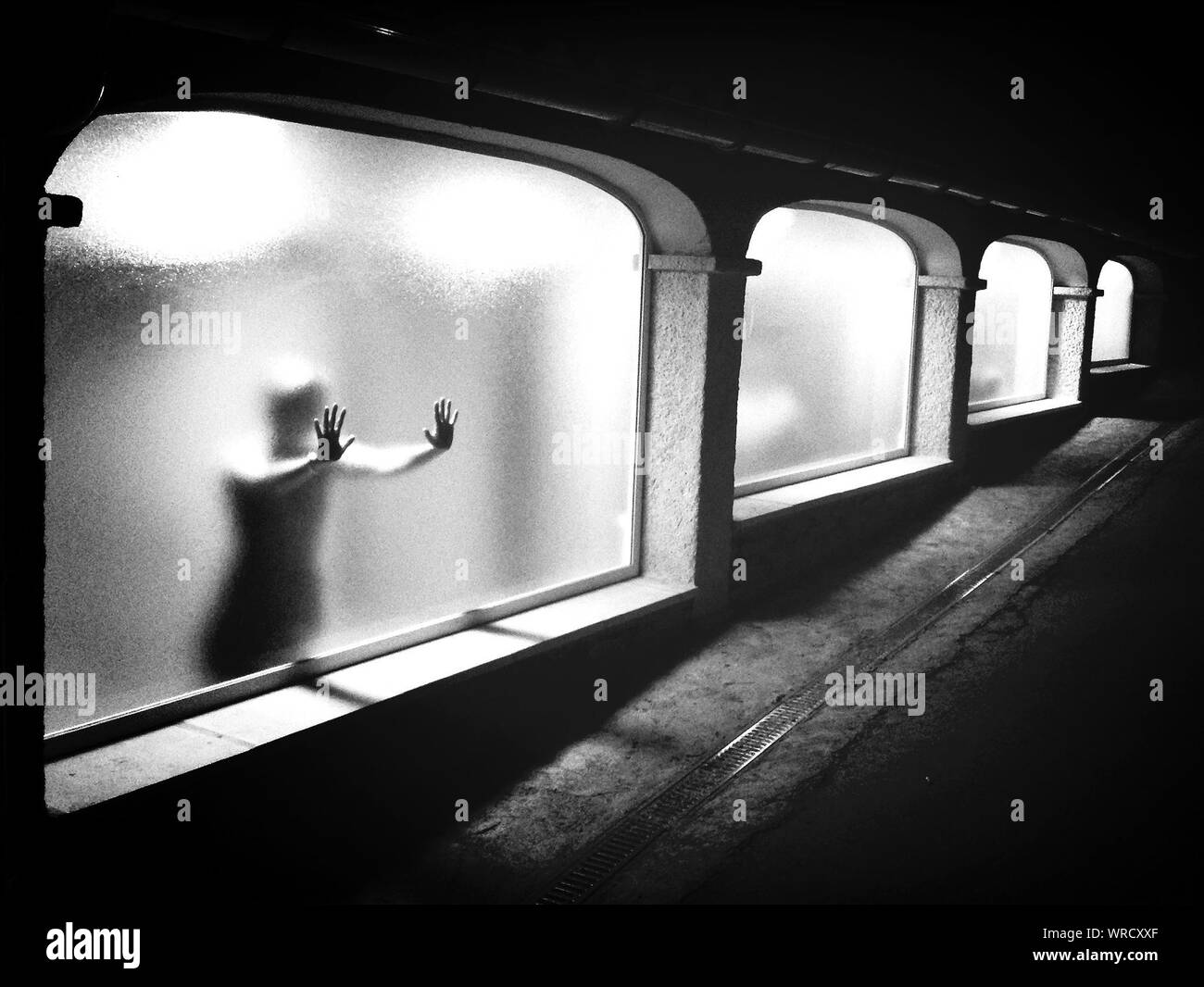Person behind a glass window Black and White Stock Photos & Images - Alamy