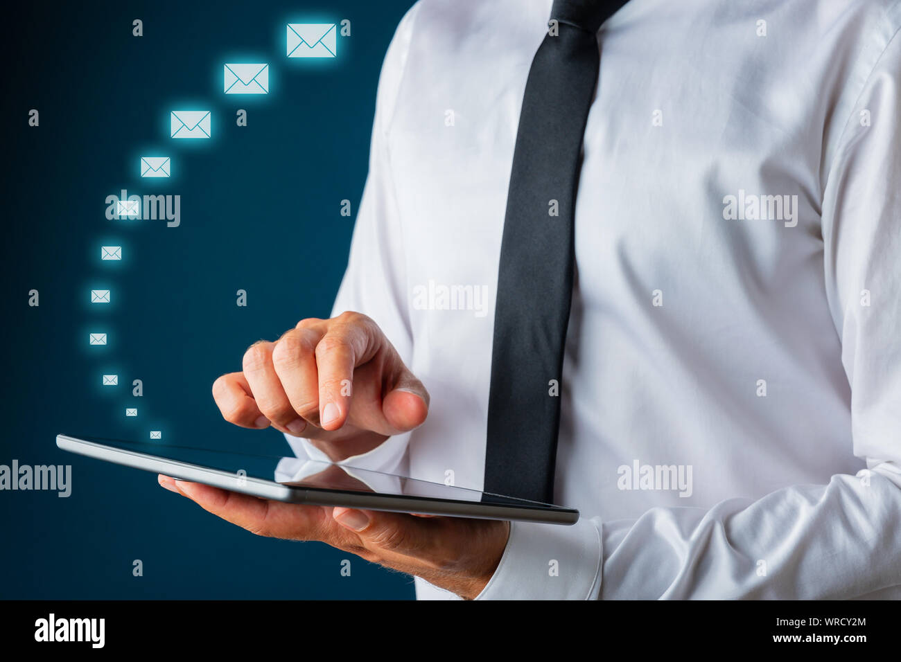 Businessman using digital tablet with shiny white envelope mail icons ...