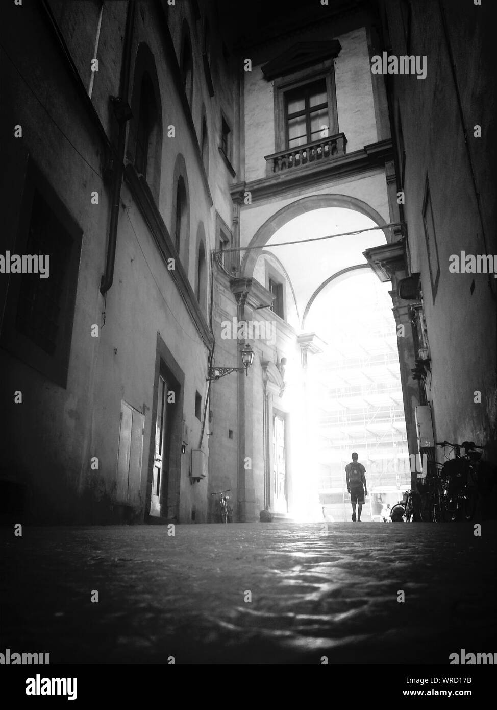 Walking under the arch Black and White Stock Photos & Images - Alamy
