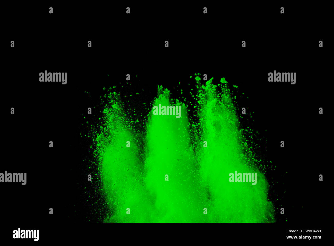Green dust particles explosion on black background Stock Photo - Alamy