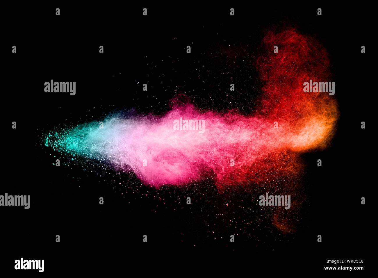 Multi colored particles explosion on black background.Colorful dust ...