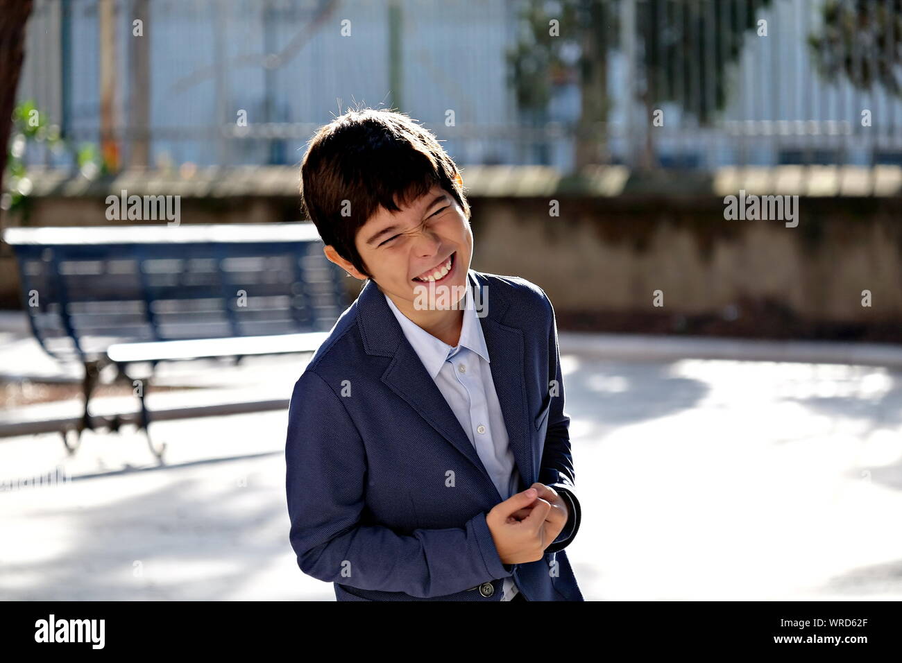 kind boy laughing in a square Stock Photo - Alamy