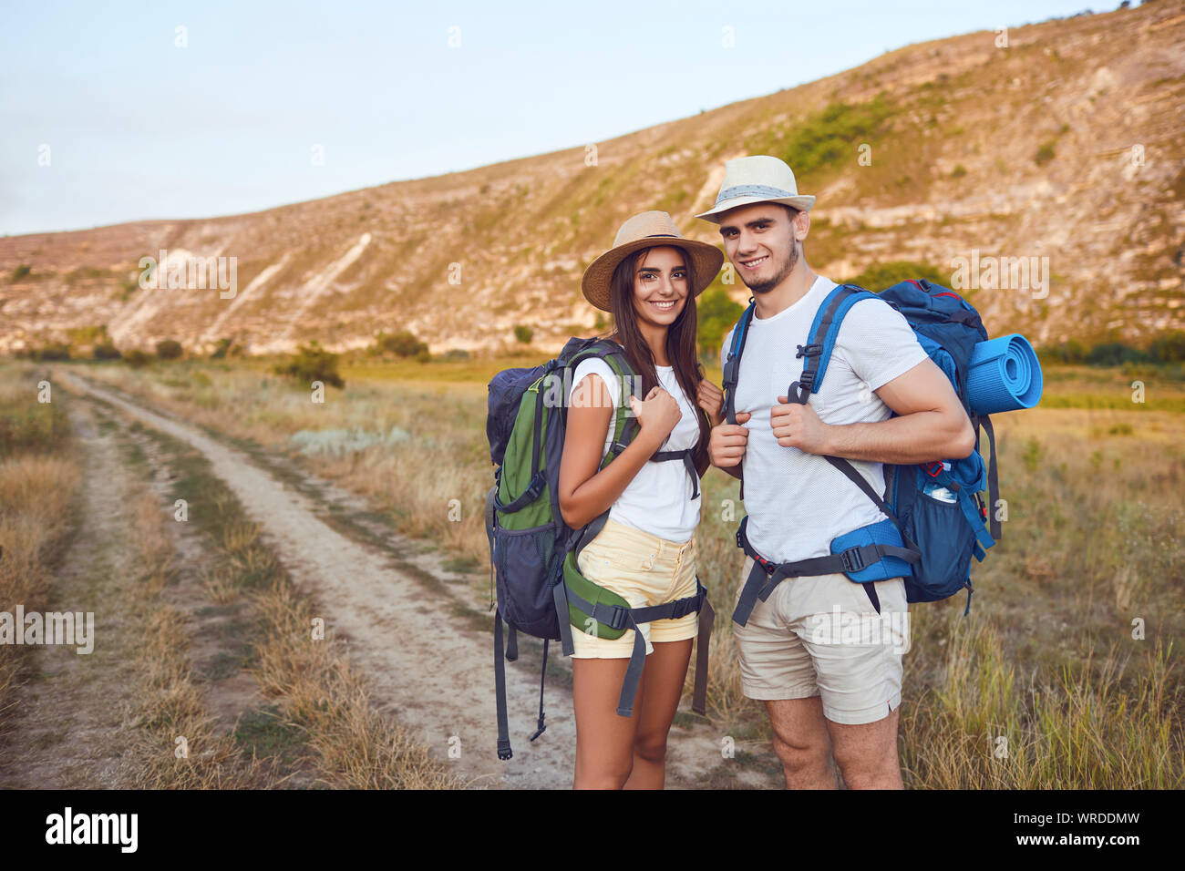 Couple hikers with backpack walking on hike in nature Stock Photo - Alamy