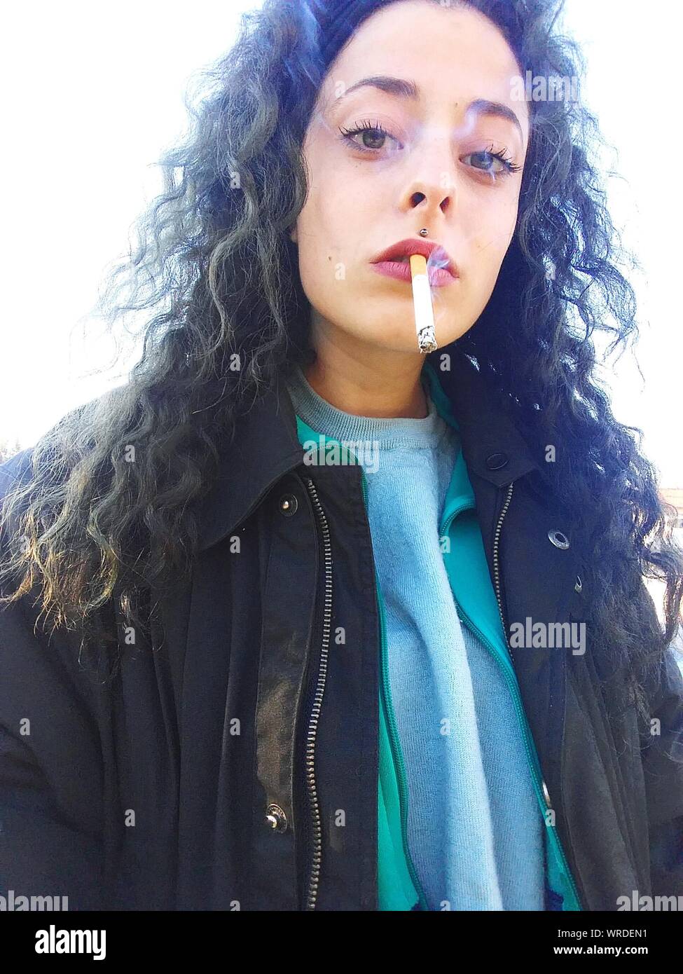 Young woman smoking cigarette hi-res stock photography and images - Alamy