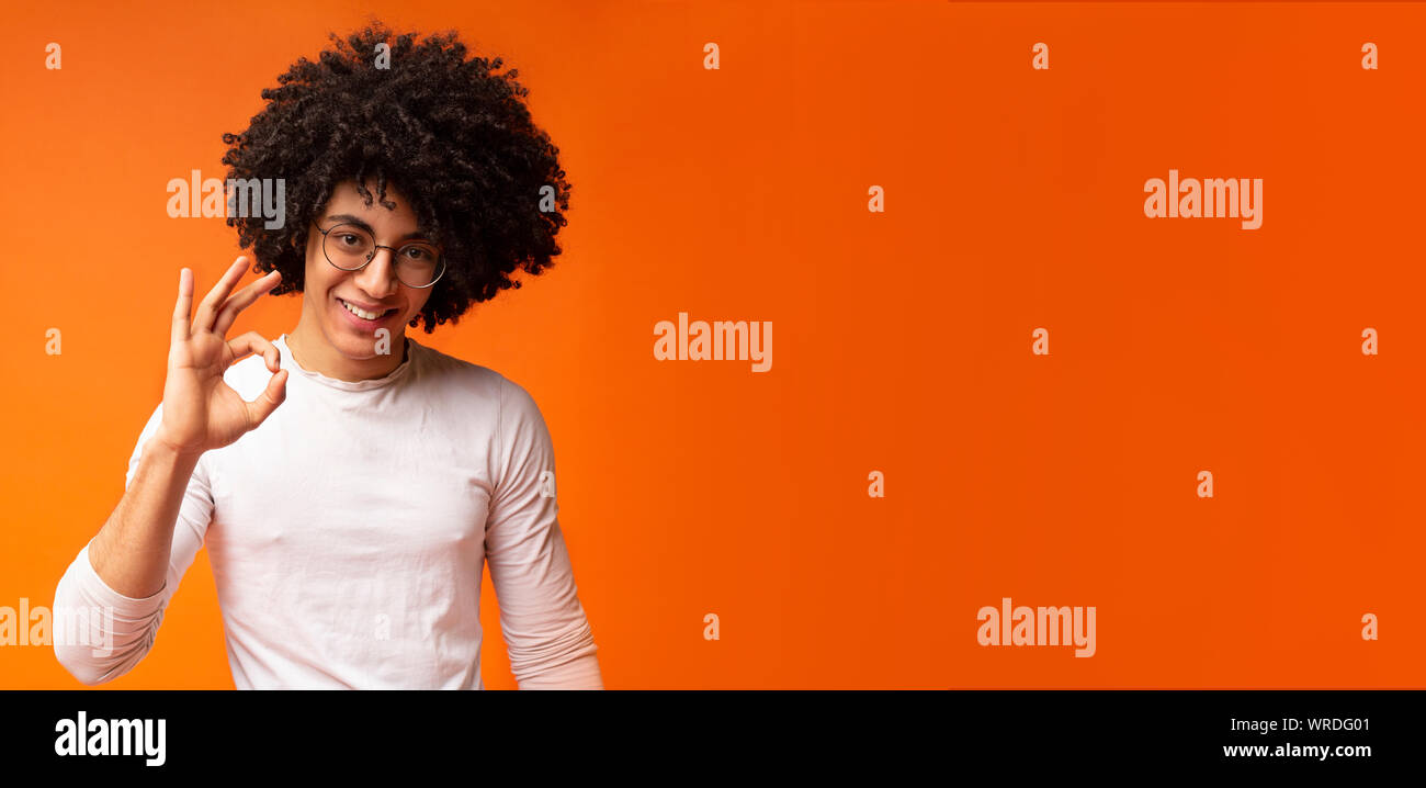 Positive black millennial man gesturing ok sign Stock Photo - Alamy