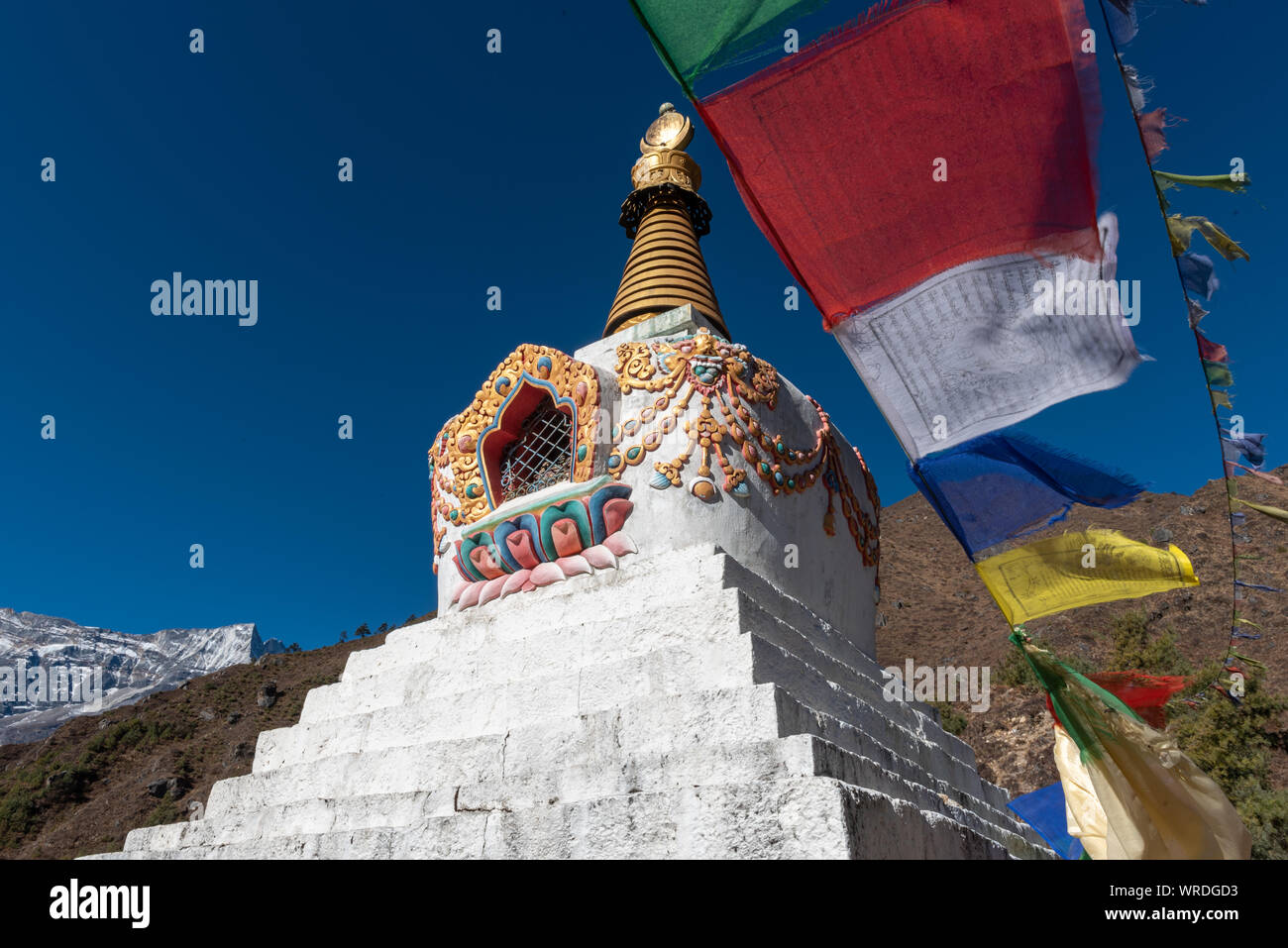 Enlightenment Stupa and prayer flags Stock Photo - Alamy