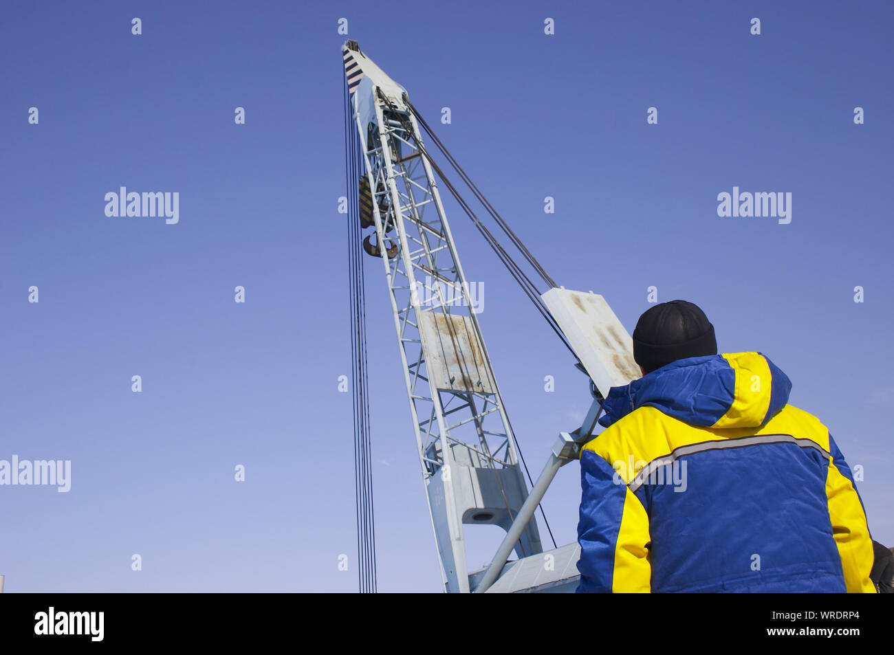 jib of the lifting crane and man Stock Photo - Alamy