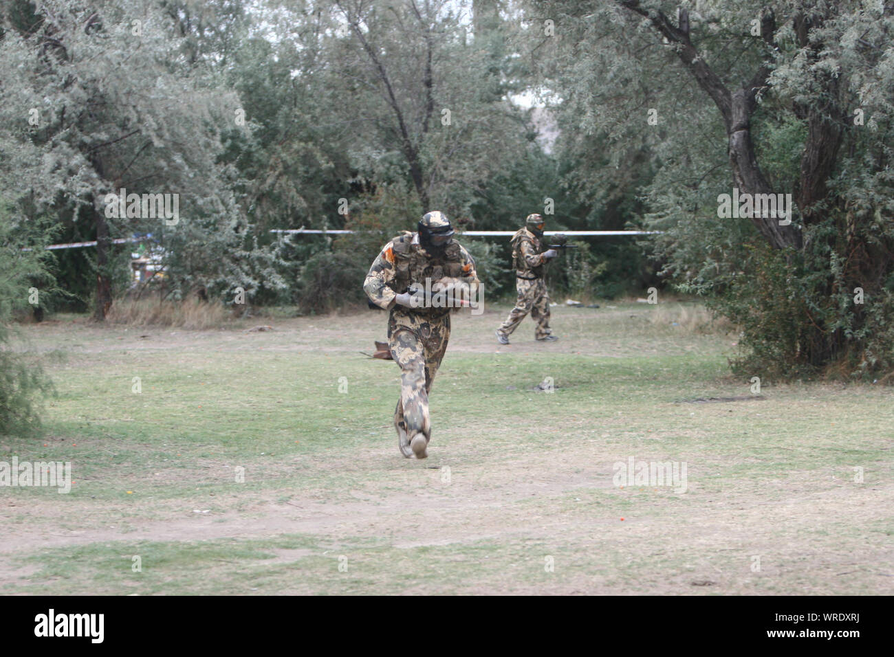 Paintball players during an attack Stock Photo - Alamy