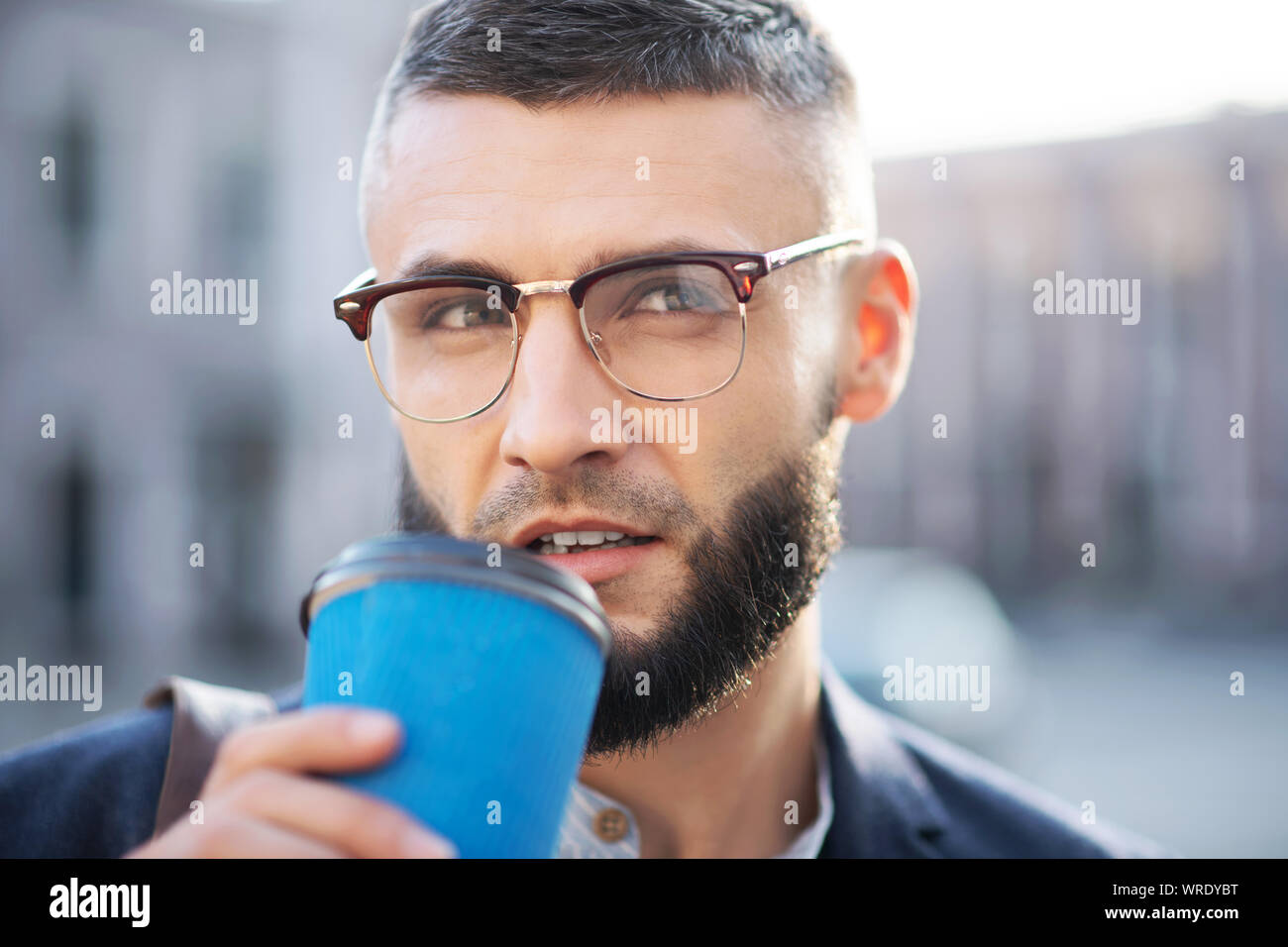 Office worker drinking coffee before entering office Stock Photo - Alamy