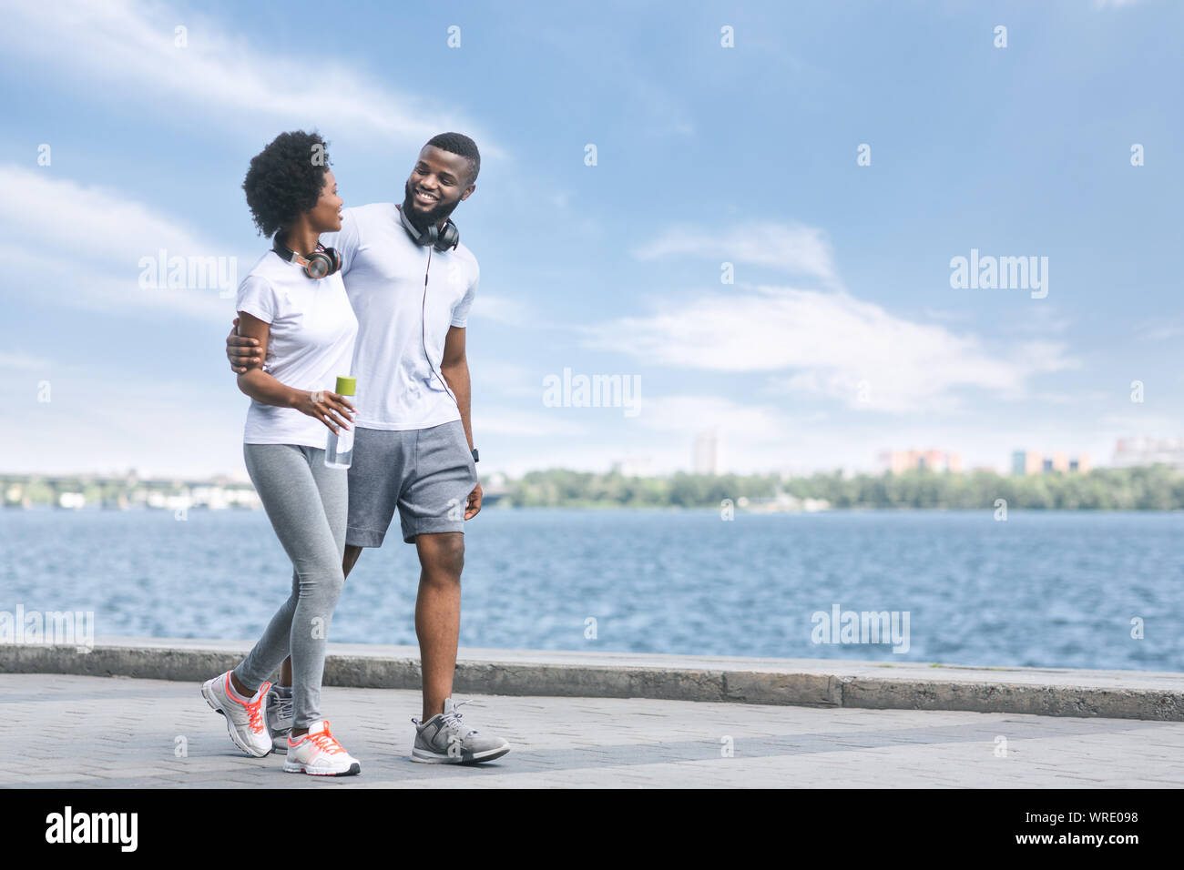 Black Couple Walking After Run Along River Embankment In Morning Stock ...