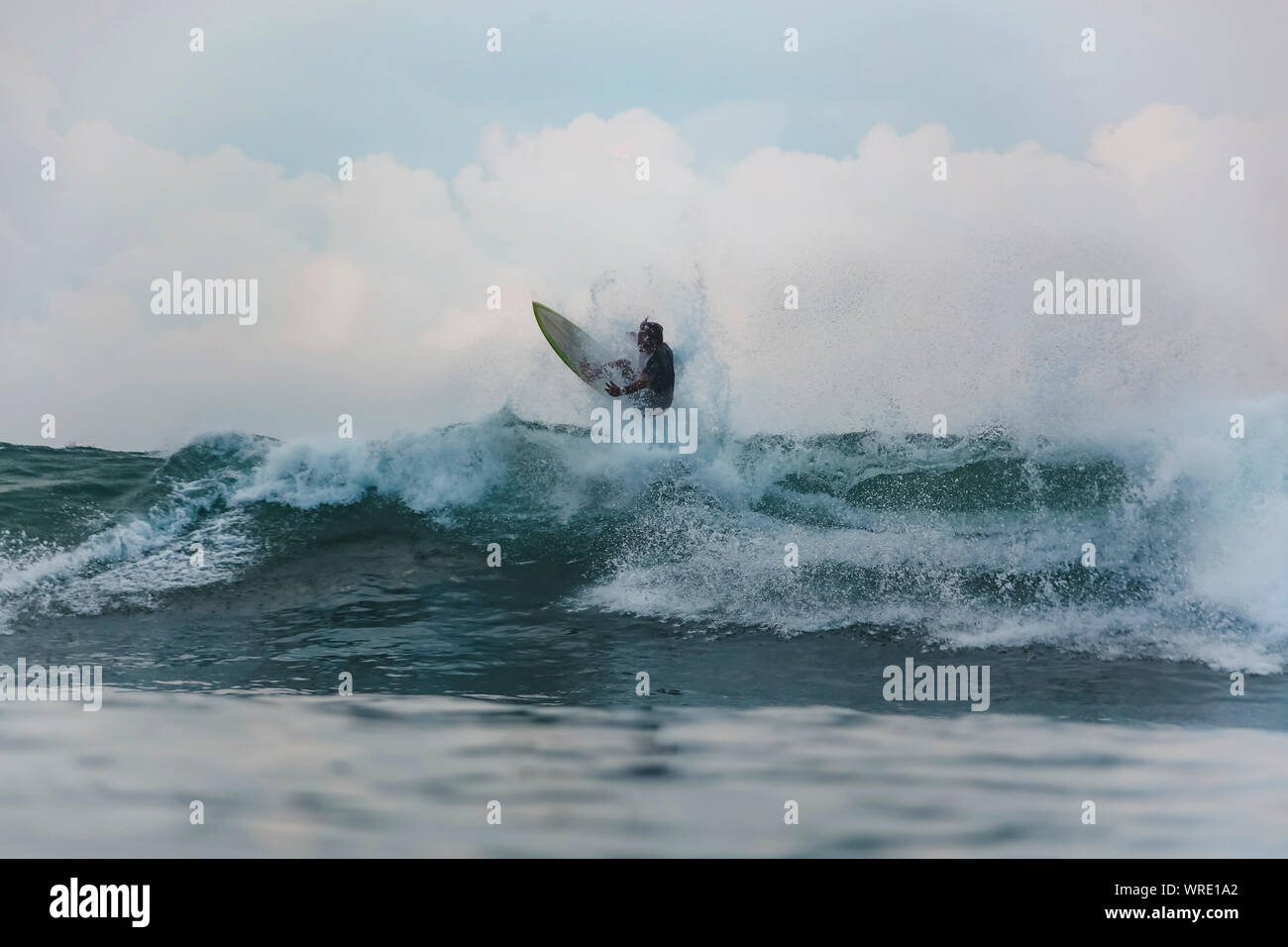 Surfer on a wave Stock Photo - Alamy
