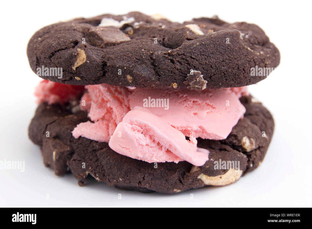 Two chocolate cookies with cherry ice cream sandwiched between them ...