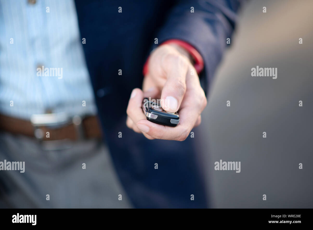 Businessman holding car keys while running late for work Stock Photo ...