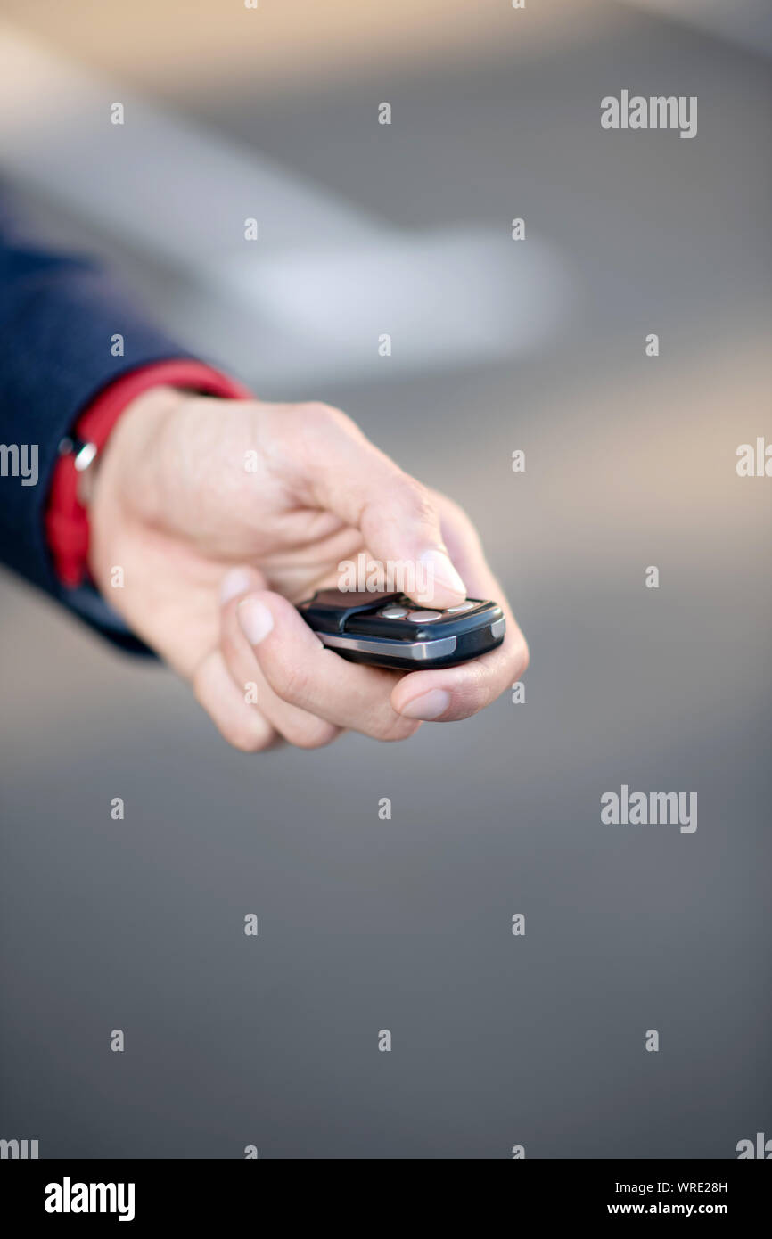 Close up of man wearing red watch holding car keys Stock Photo - Alamy
