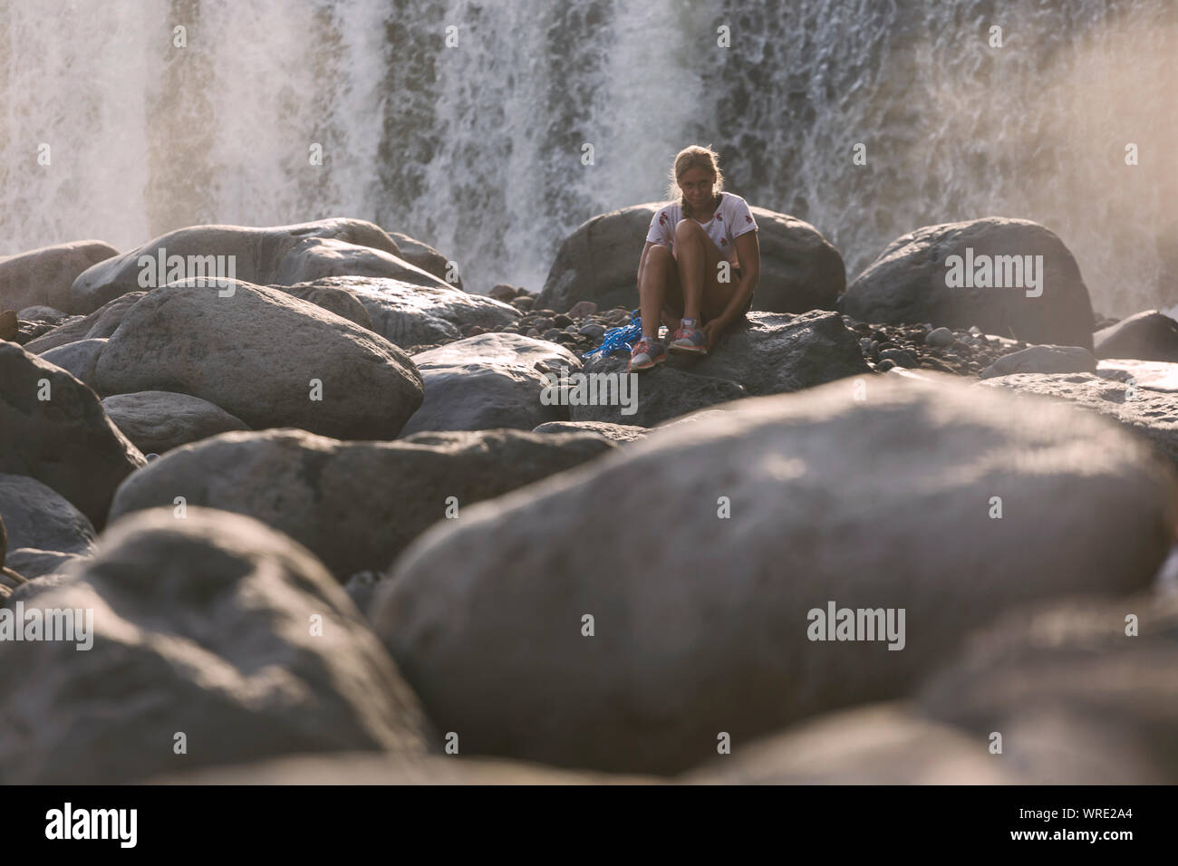 Person sitting by water feature hi-res stock photography and images - Alamy