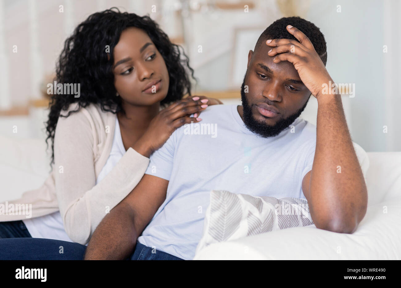 Young African Woman Comforting Her Upset Boyfriend Stock Photo Alamy