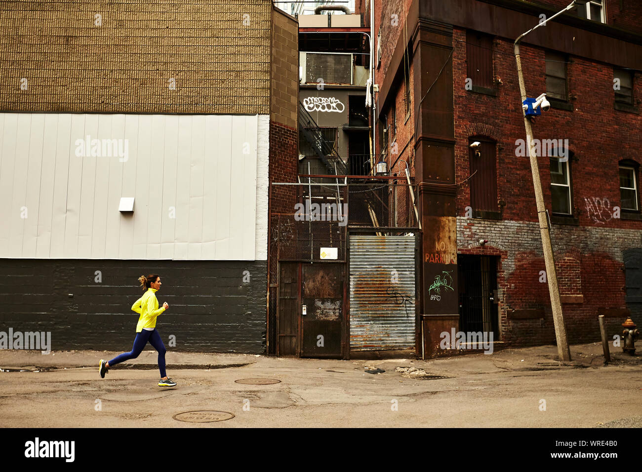A woman running through an urban city environment Stock Photo - Alamy