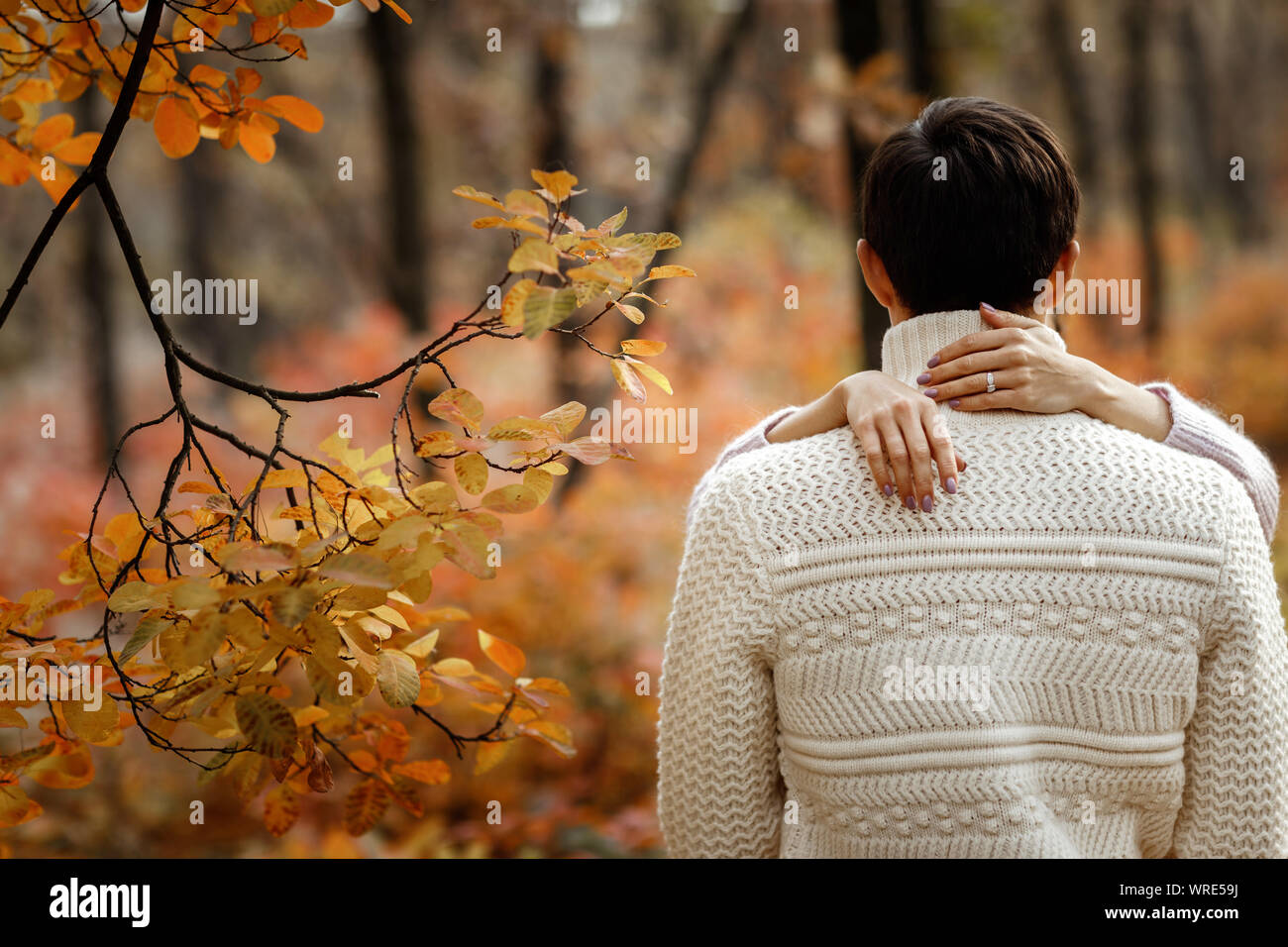 Couple in love hugging in beautiful autumn day in park. Woman hugging a ...