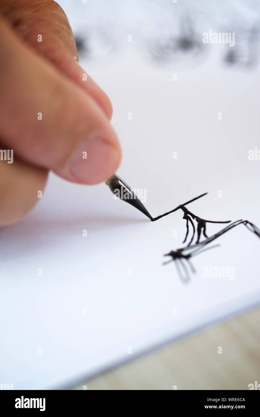 Senior man drawing with pen Stock Photo - Alamy