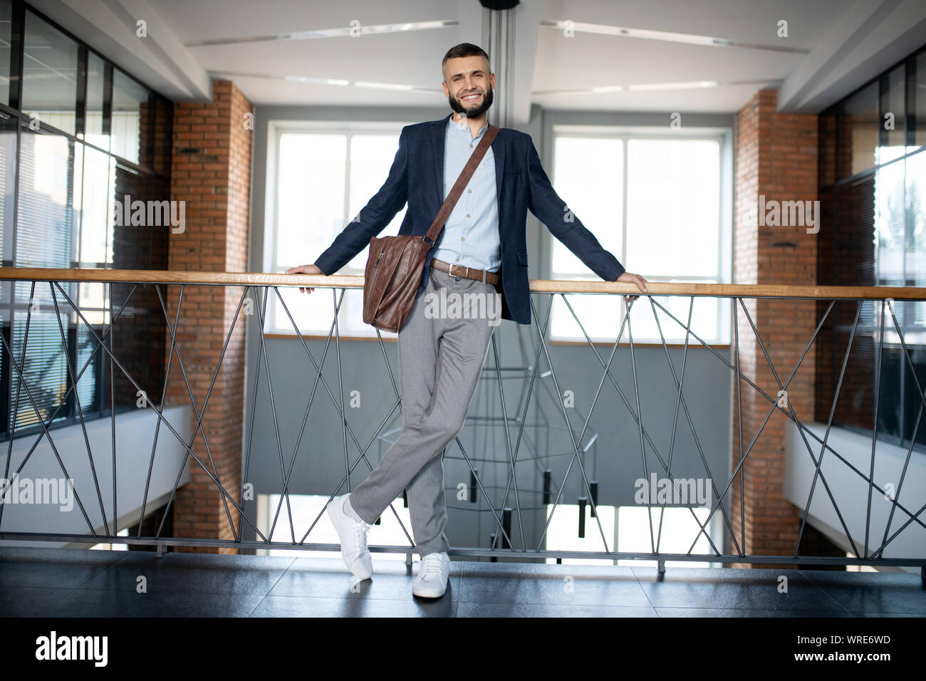 Office worker standing and waiting for his colleague near stairs Stock ...