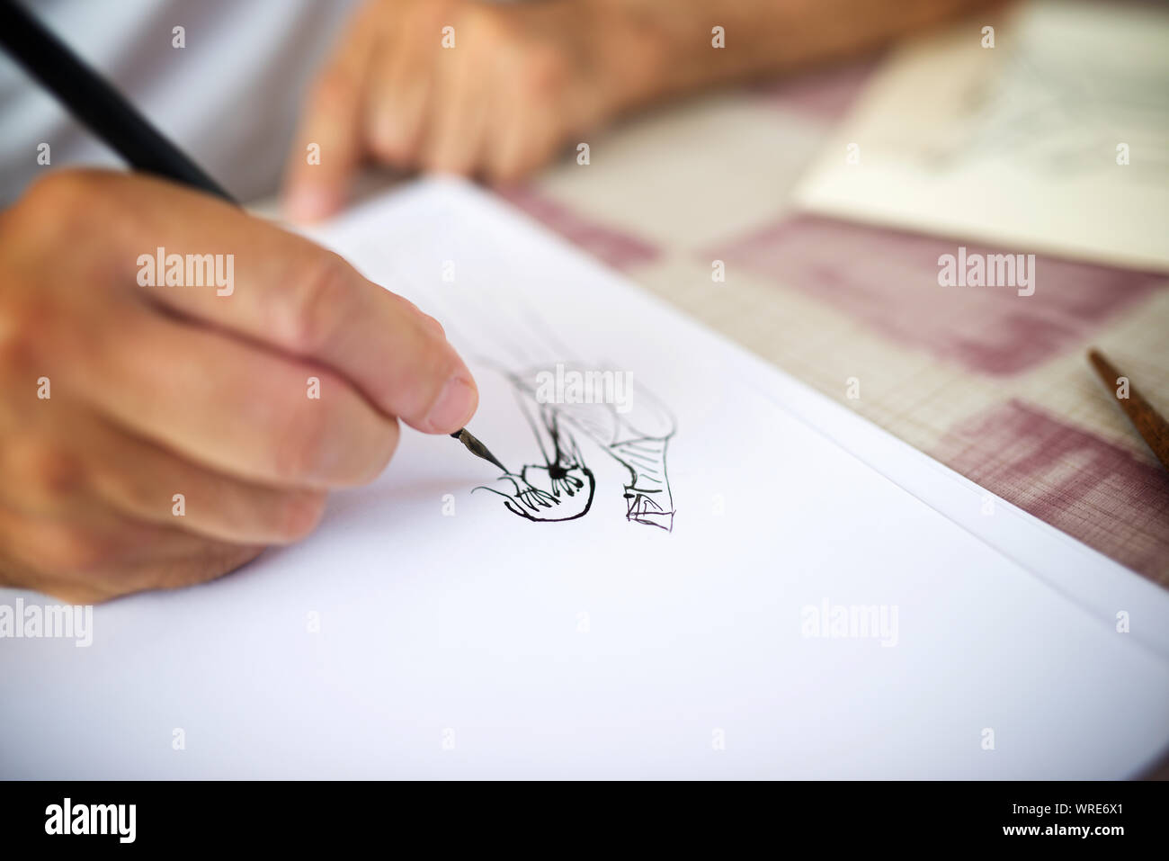 Senior man drawing with pen Stock Photo - Alamy