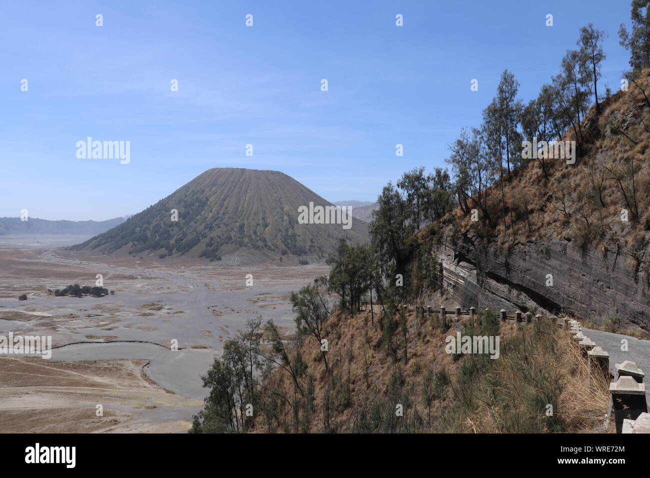 Off-road jeeps go up a steep hill on the slope of Bromo caldera to the ...